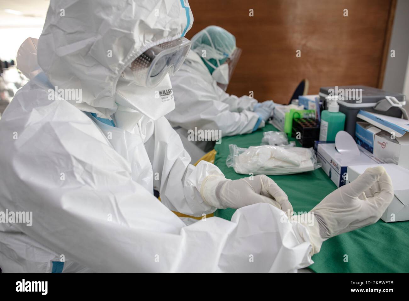 Medical team checking his hand gloves before the swab test. South ...