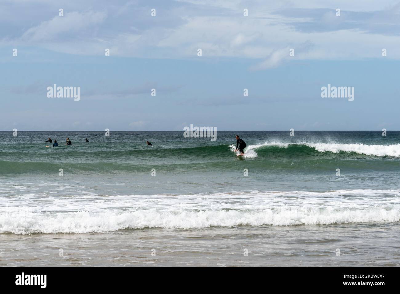 Newquay, United Kingdom - 4 Spetember, 2022: surfer catching a wave at ...