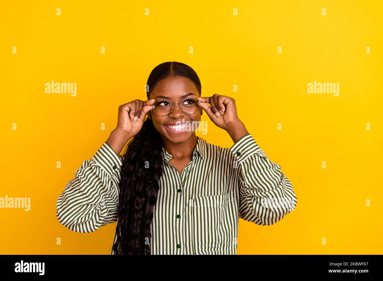 Photo of cute millennial brunette lady hands glasses look up wear ...