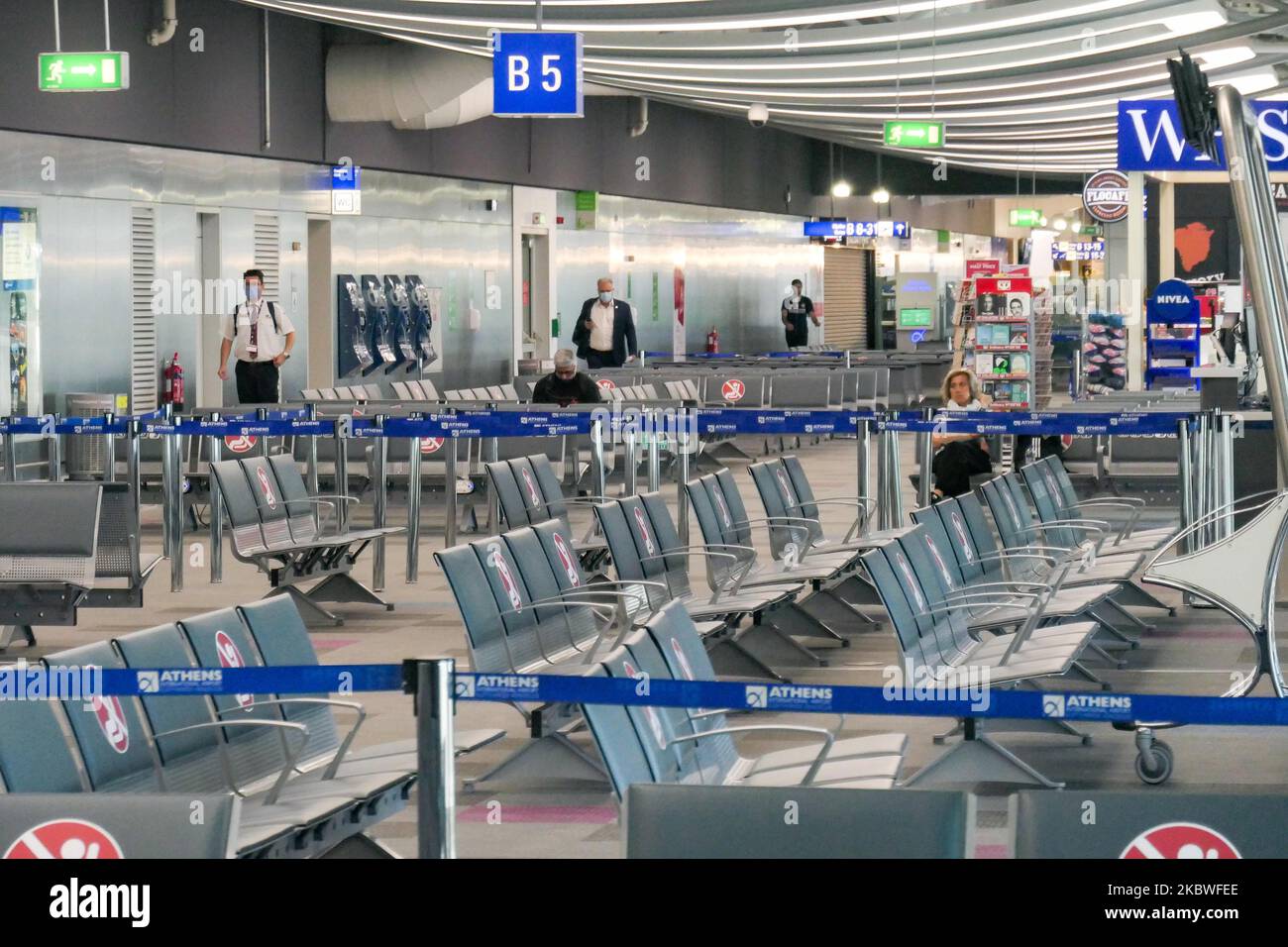 Passengers waiting with facemask, checking in at the counter for ...
