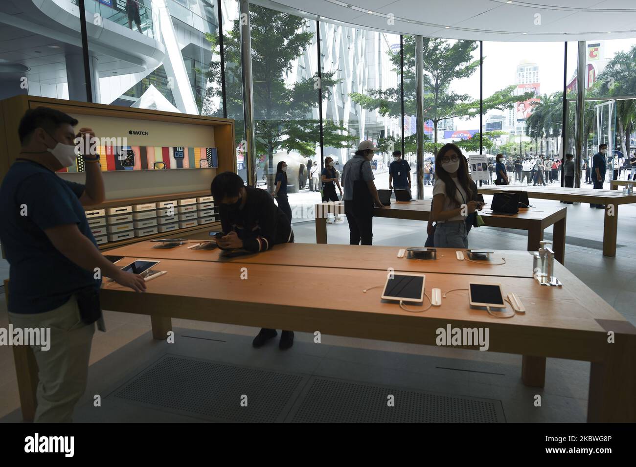 Customers inspect Apple devices at the new Apple Store at the shopping ...