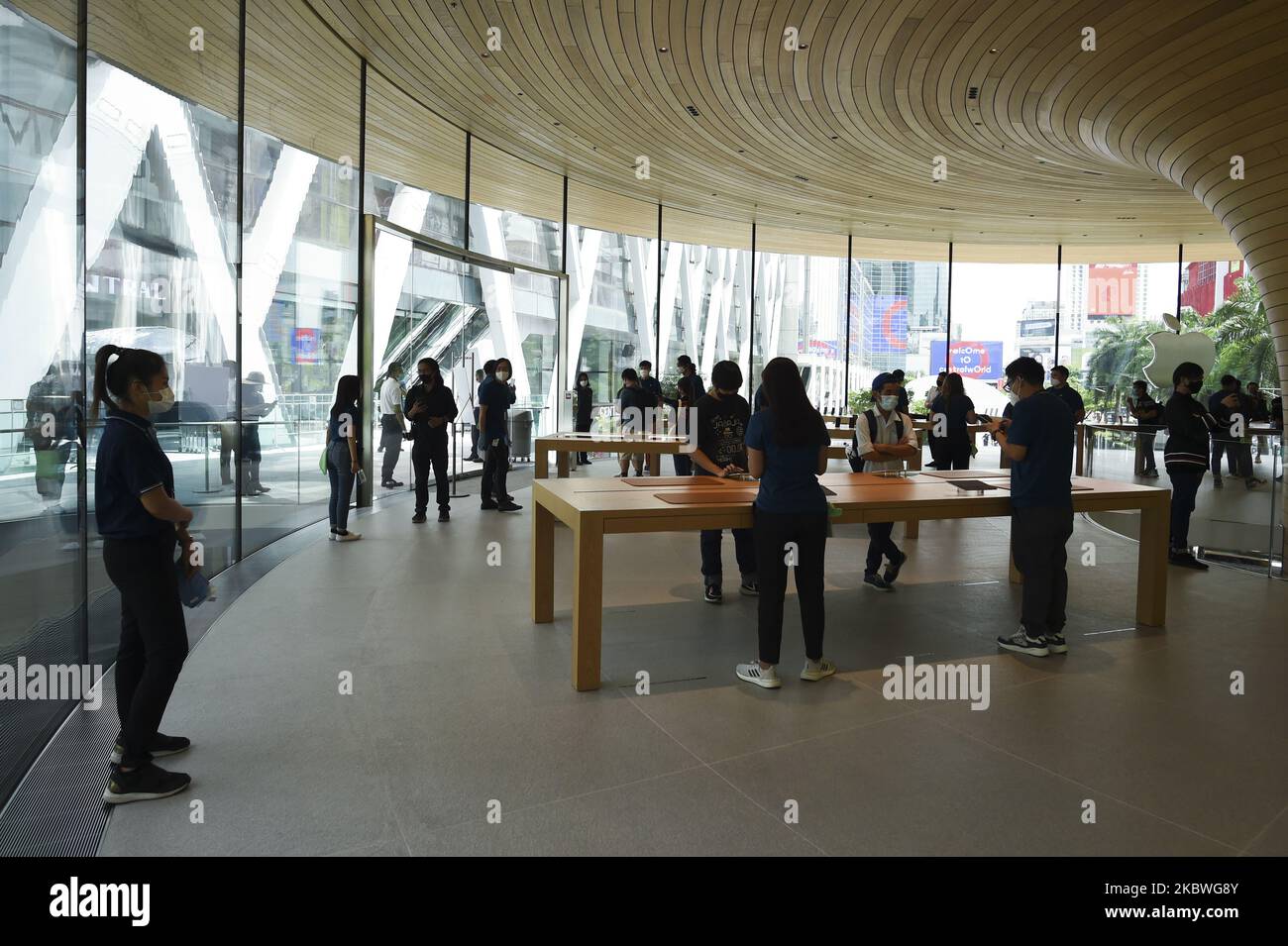Customers inspect Apple devices at the new Apple Store at the shopping ...