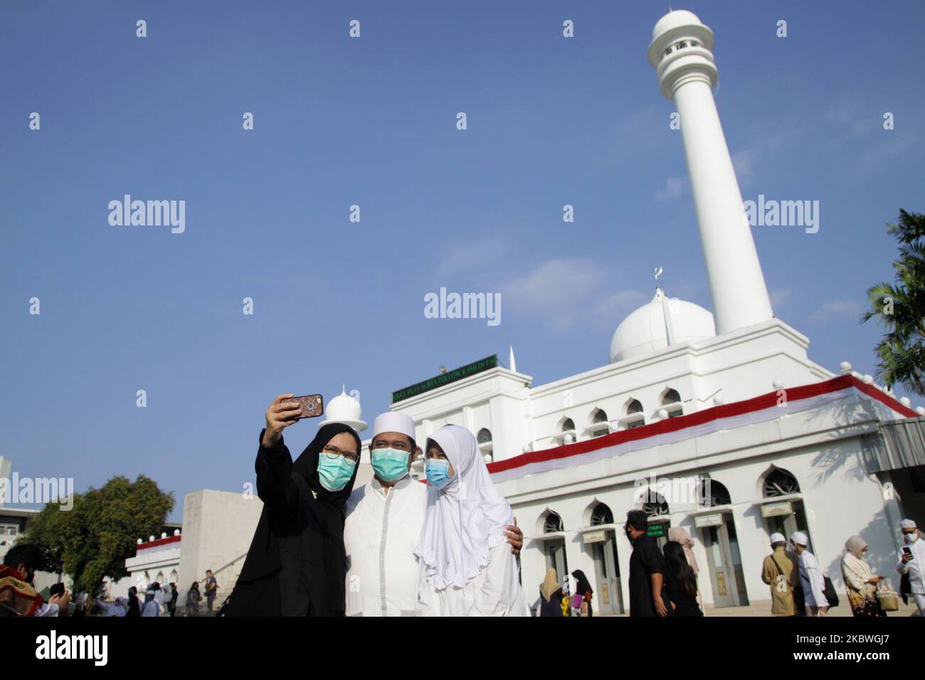 Indonesian muslims family wearing protective face mask took a ...