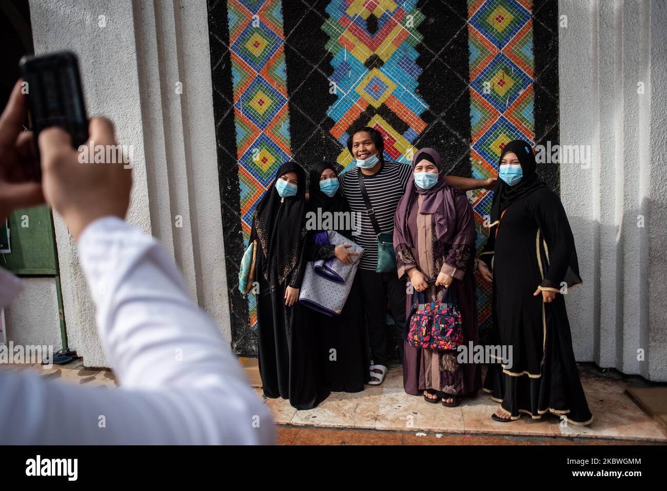 A Filipino Muslim family has their photo taken after prayers during Eid ...