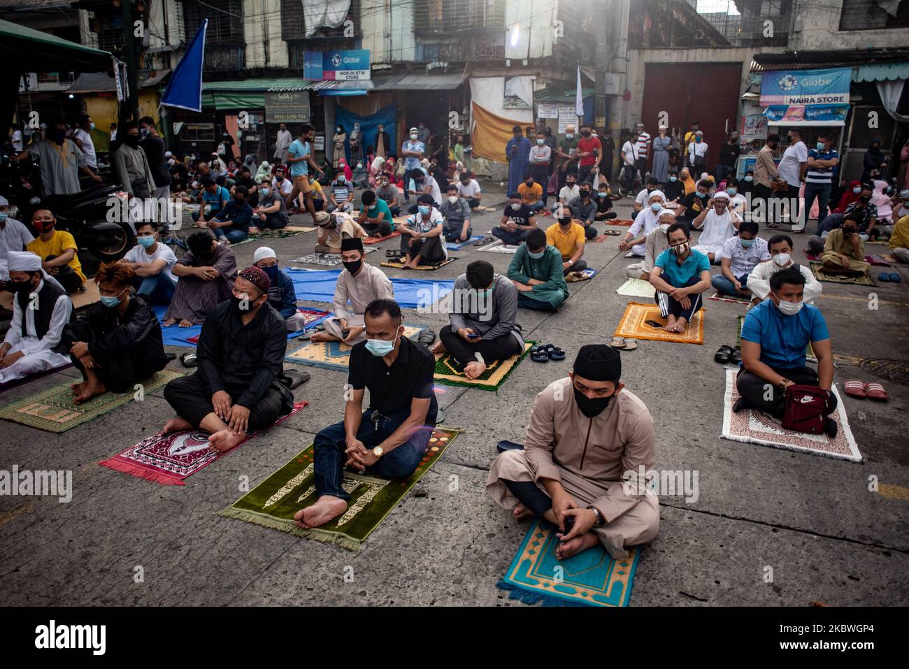 Filipino Muslims pray along the street outside the mosque during Eid'l ...