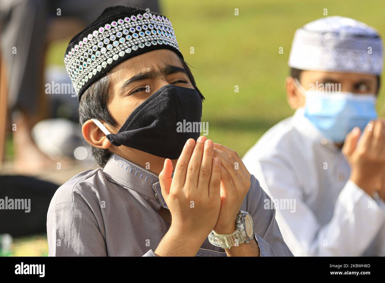 A Muslim boy wearing a face mask attends prayers to mark the Eid al ...