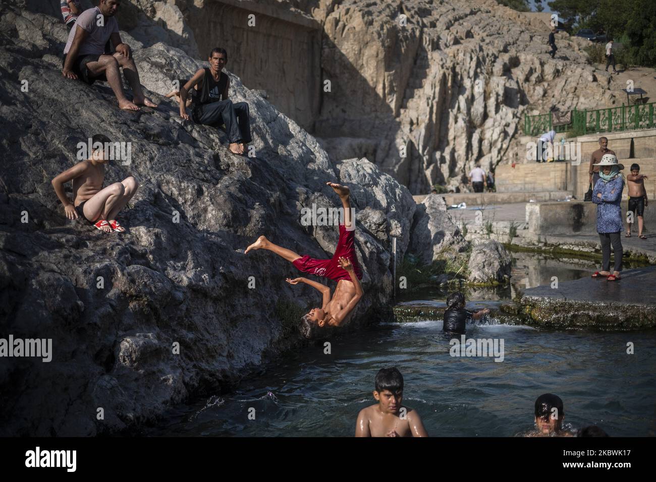 An Iranian boy dives in the Cheshmeh-Ali natural fountain in Shahr-e ...
