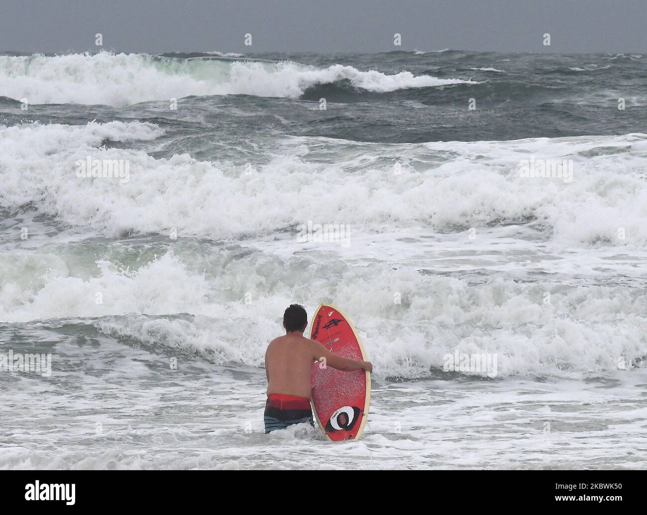 A surfer fights heavy waves at Lighthouse Point Park as Tropical Storm ...