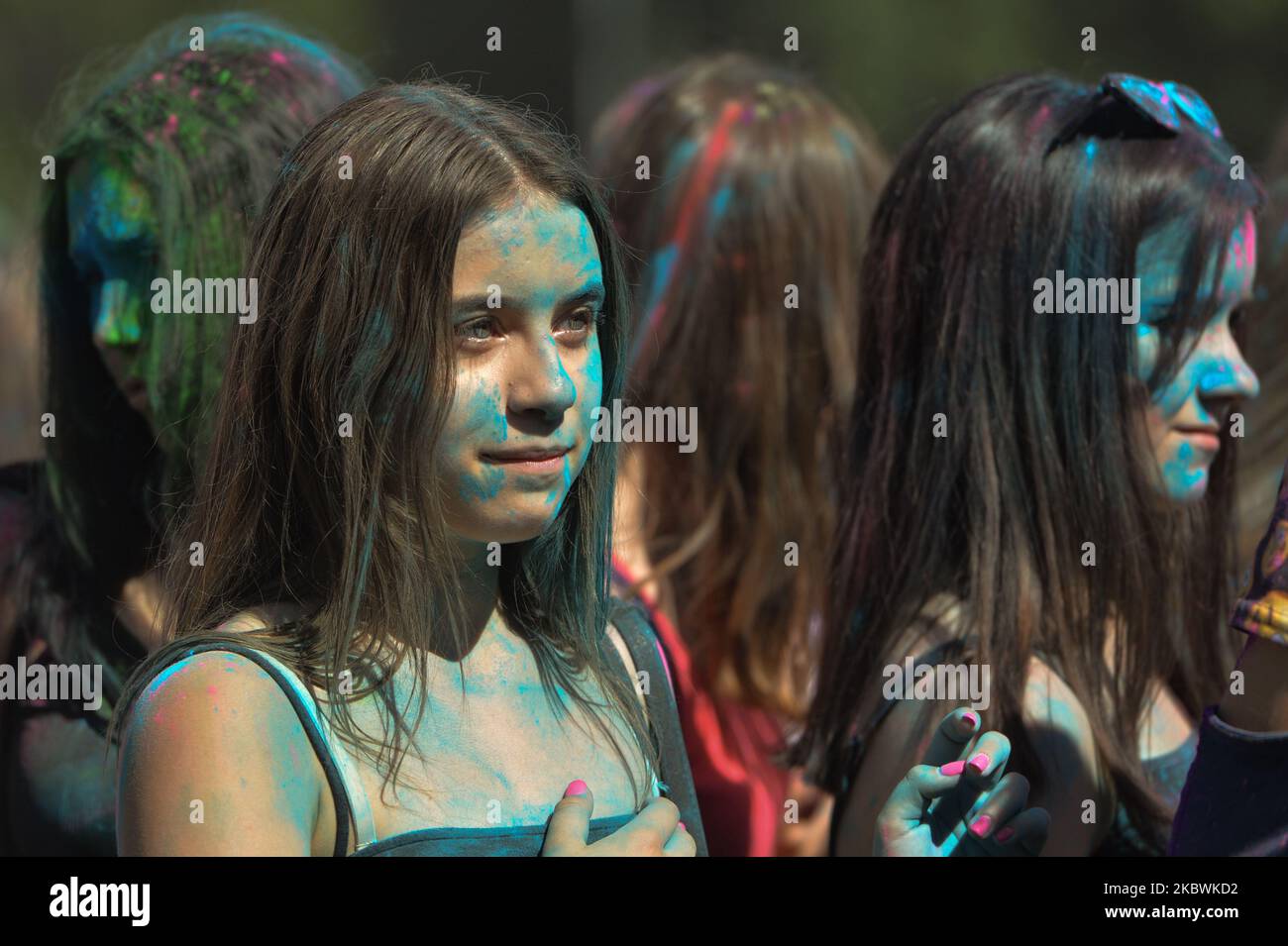 Young people play with colour powder during Holi celebrations, a ...