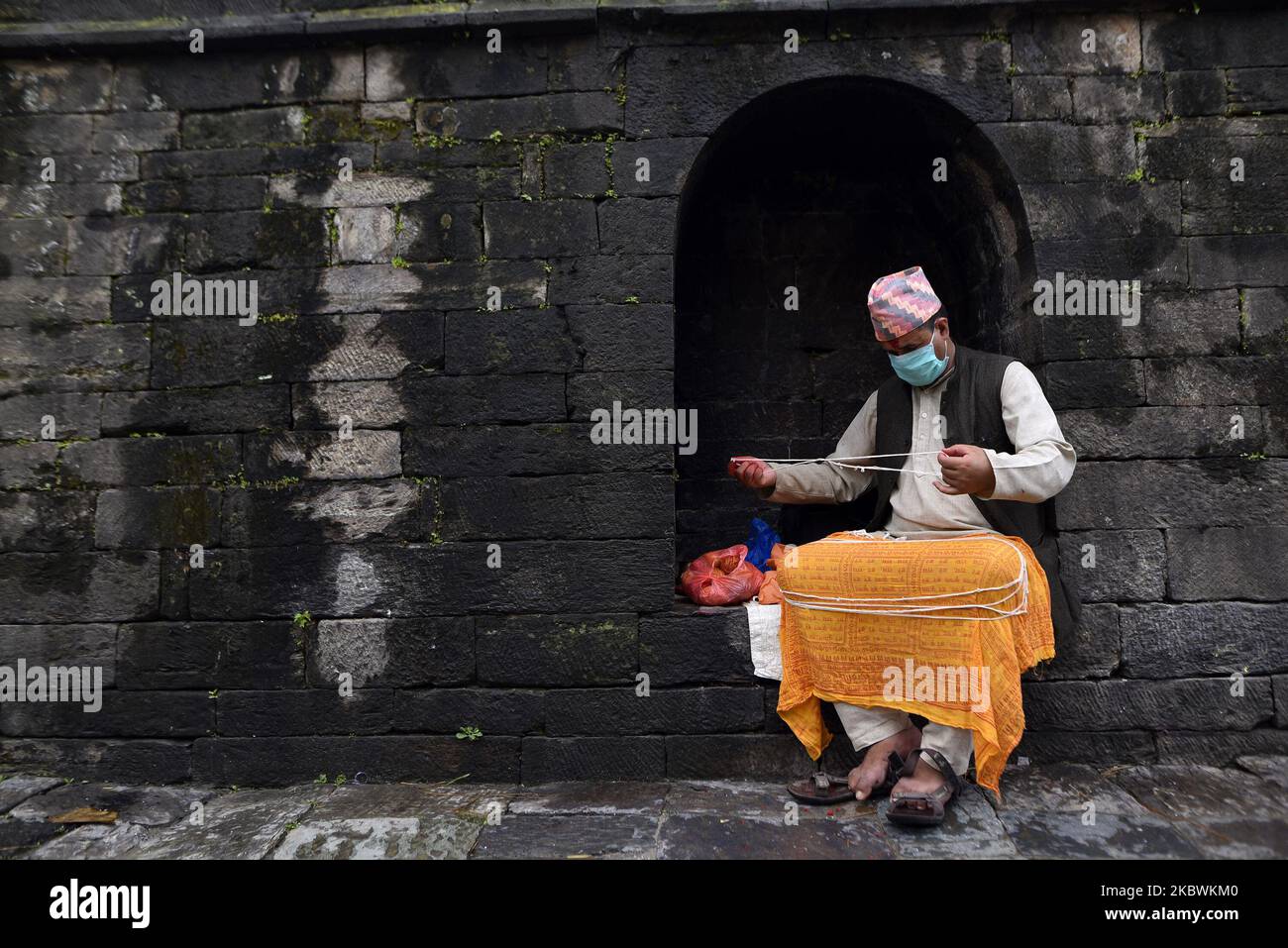 A Priest arranging a sacred colorful thread during Janai Purnima ...