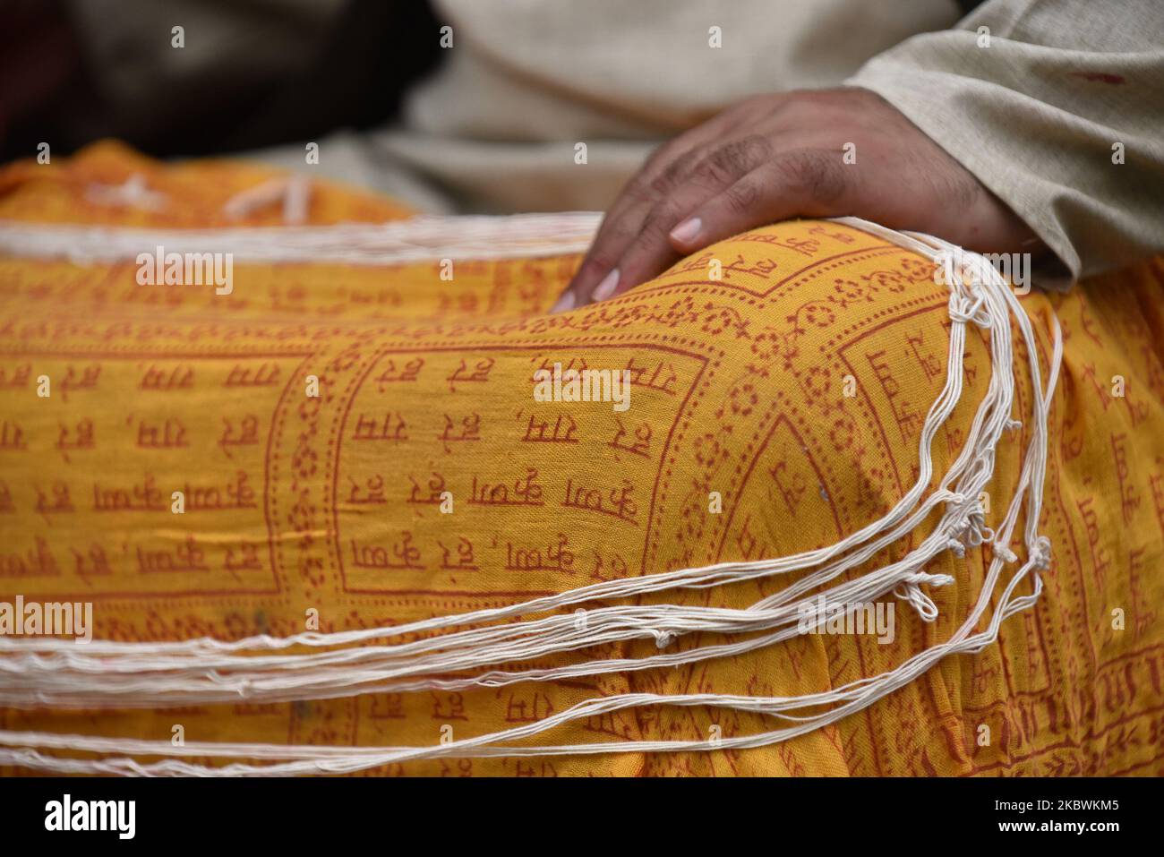 A Priest arranging a sacred colorful thread during Janai Purnima ...