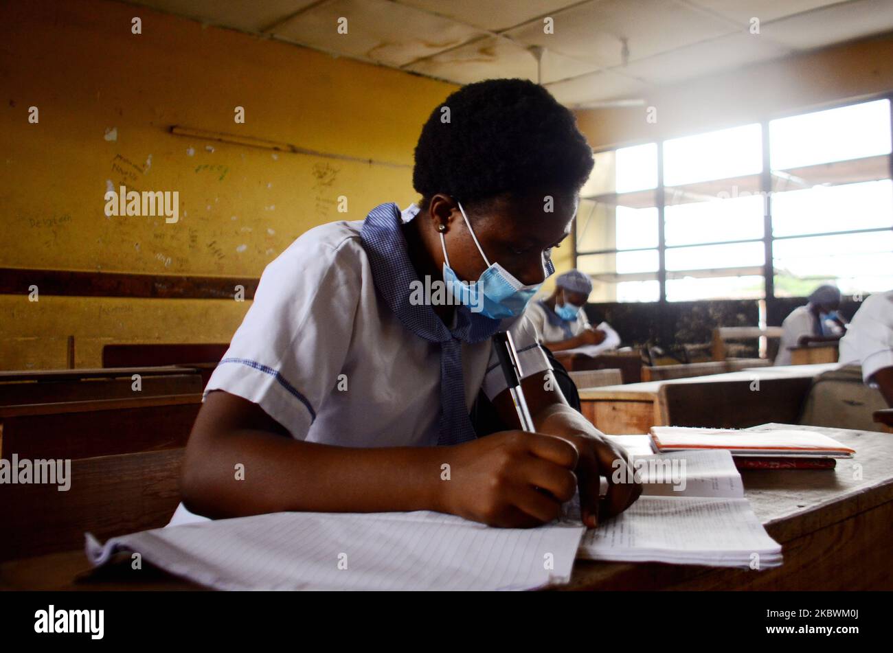 High School students wears a face mask while they reads in a classroom ...