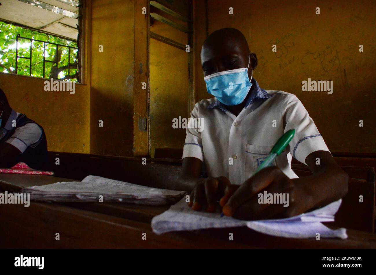 High School students wears a face mask while they reads in a classroom ...