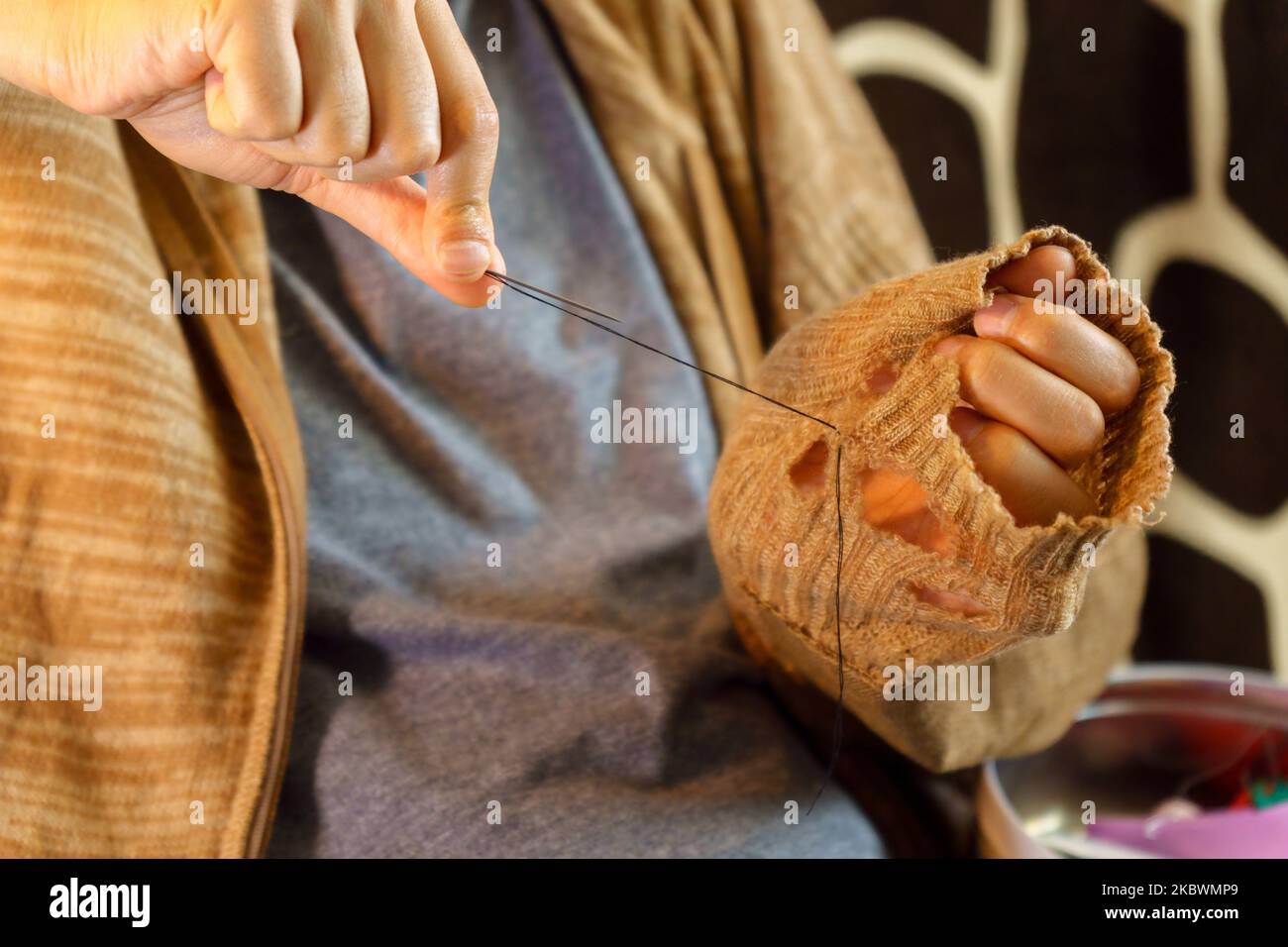 Mending clothes. Concept of mending and repairing clothes. Creative ...