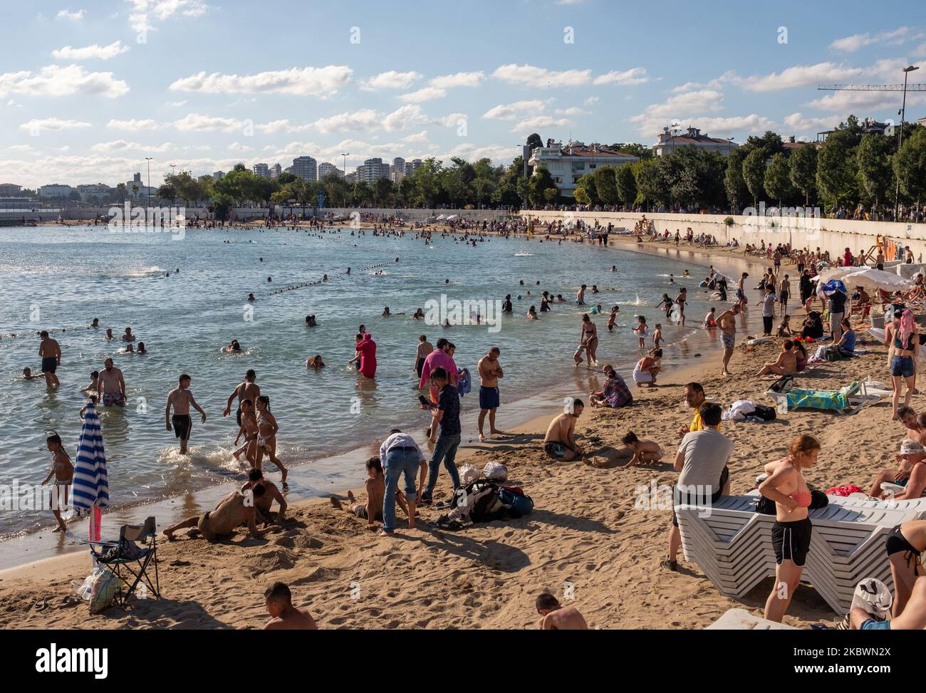 People swimming and sunbathing at a public beach in Istanbul, Turkey on ...