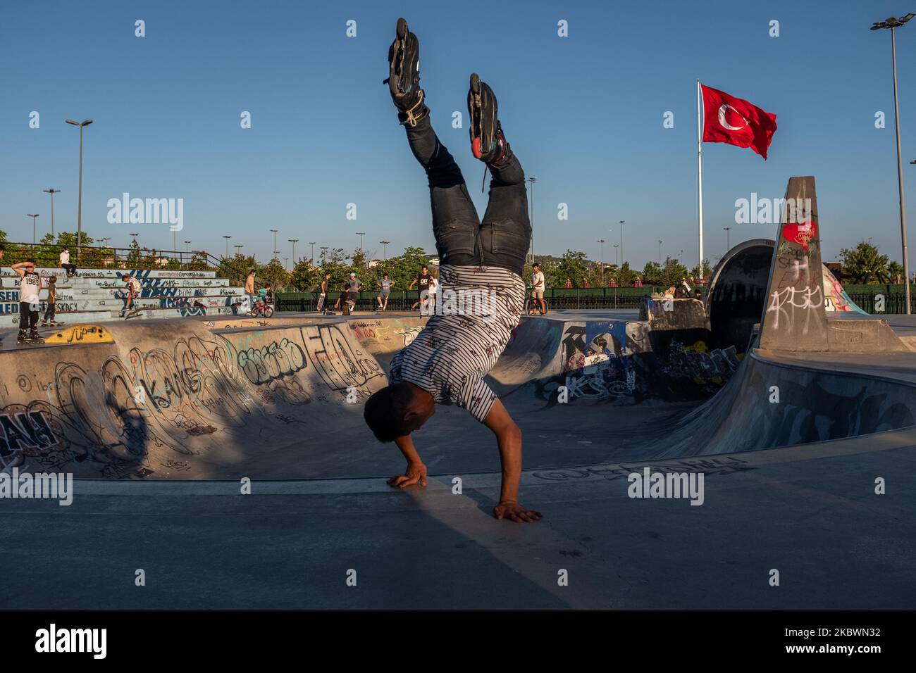 Teenagers skate and perform tricks at a local skatepark in Istanbul ...