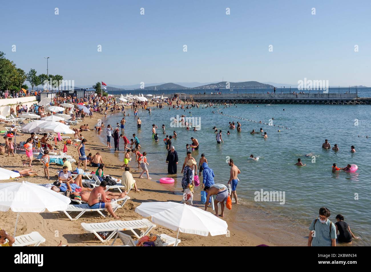 People swimming and sunbathing at a public beach in Istanbul, Turkey on ...