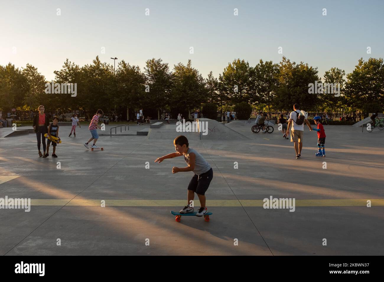 Teenagers skate and perform tricks at a local skatepark in Istanbul ...