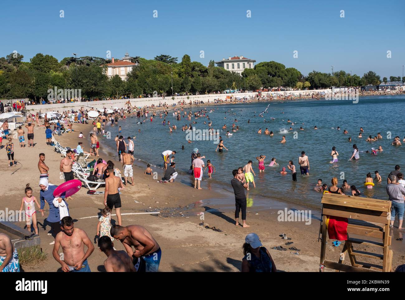 People swimming and sunbathing at a public beach in Istanbul, Turkey on ...