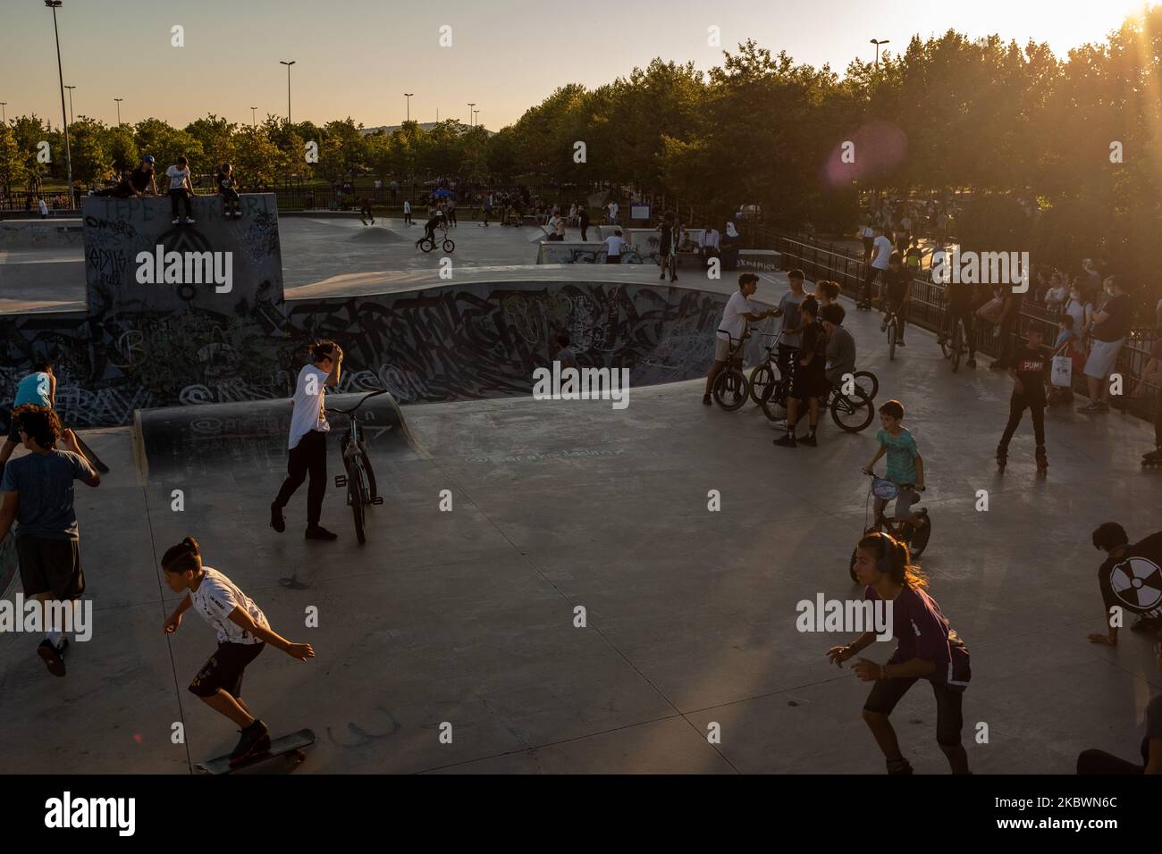 Teenagers skate and perform tricks at a local skatepark in Istanbul ...