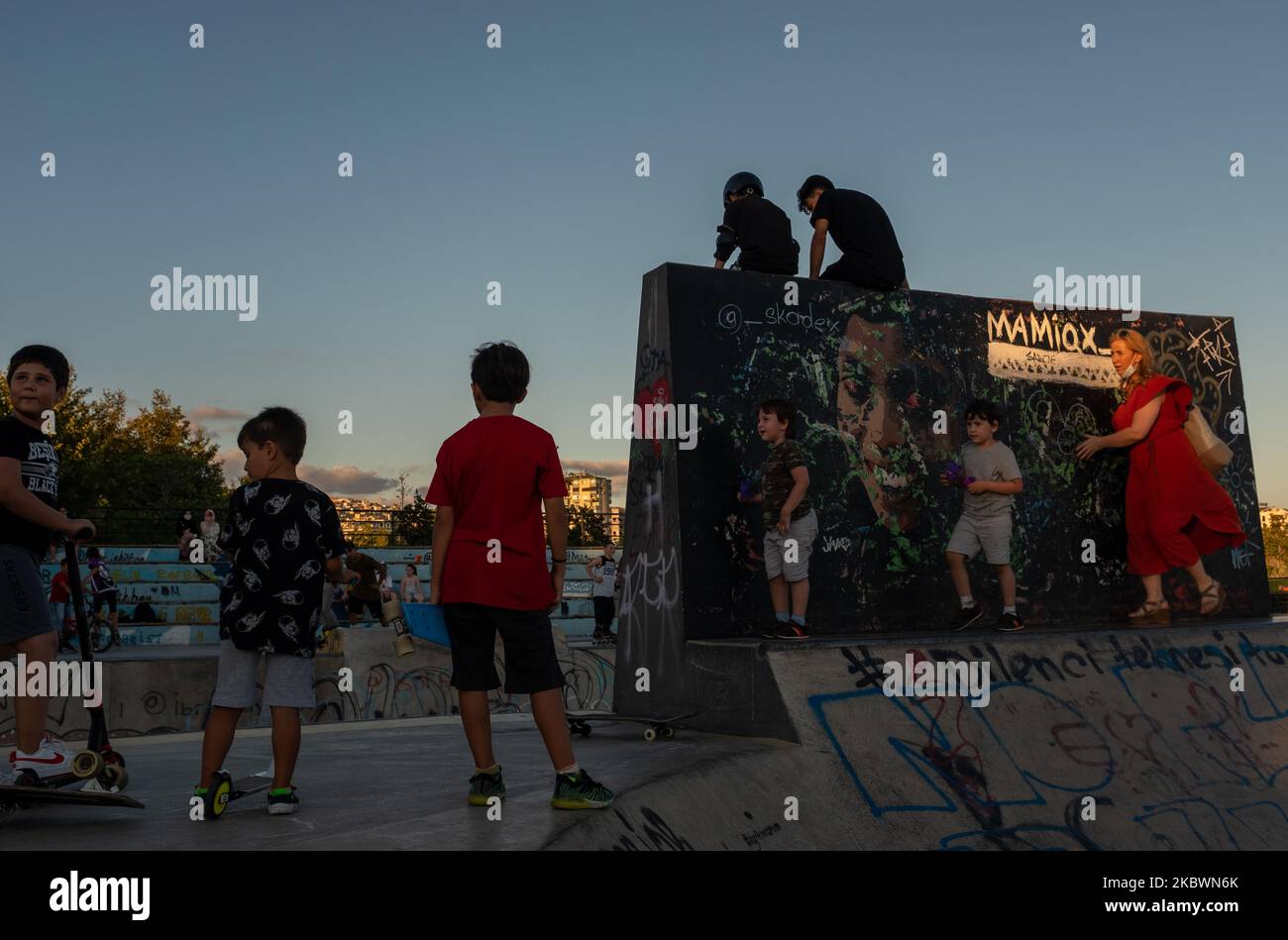 Teenagers skate and perform tricks at a local skatepark in Istanbul ...