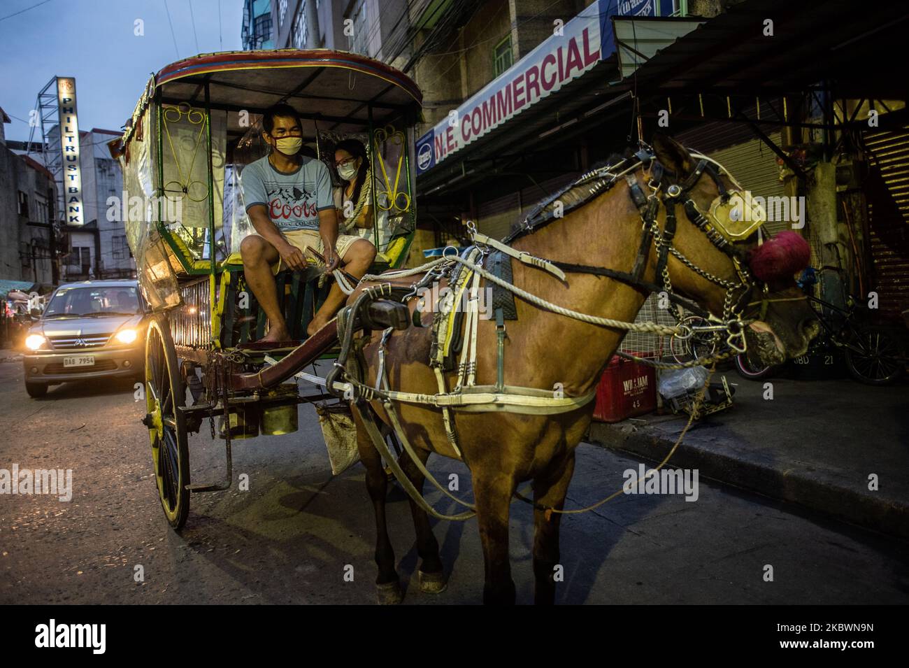 A man drives a horse-drawn carriage used as a mode of transportation in ...