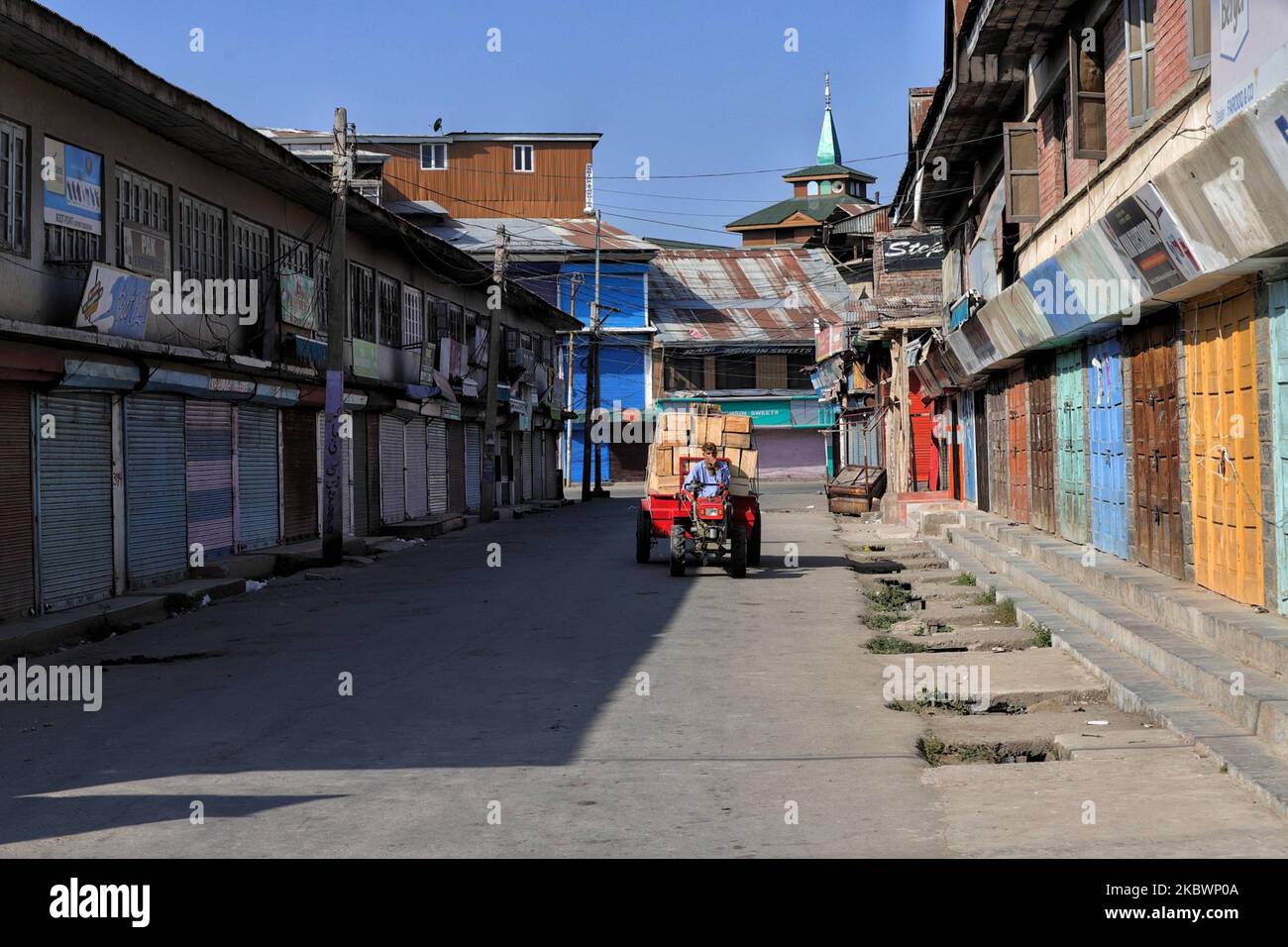 A man drives a vehicle loaded with empty Apple Boxes in Sopore Town of ...