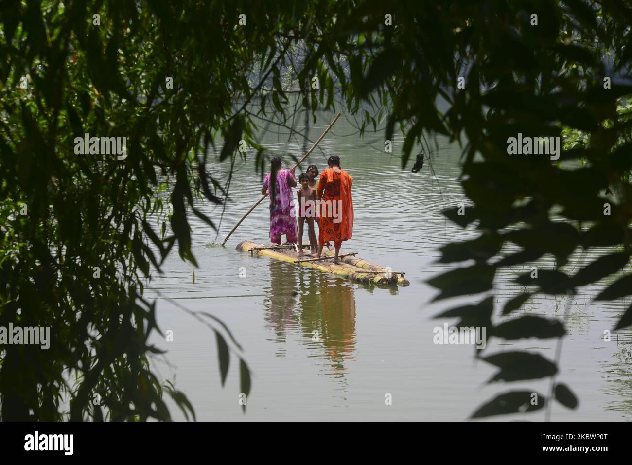 Villagers ride on makeshift raft made of banana trees in the flood ...