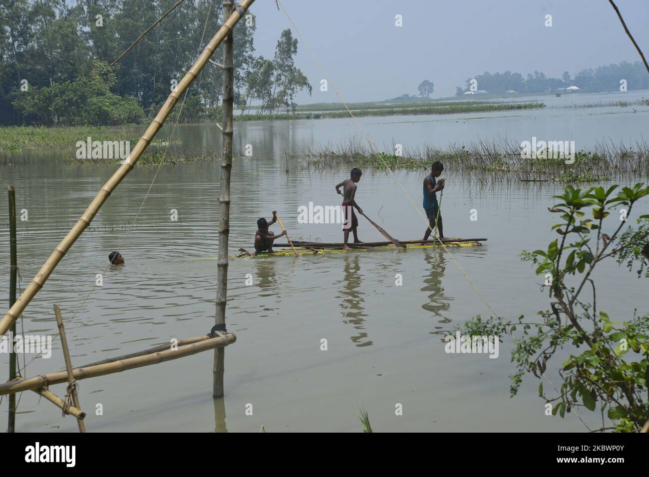 Villagers ride on makeshift raft made of banana trees in the flood ...