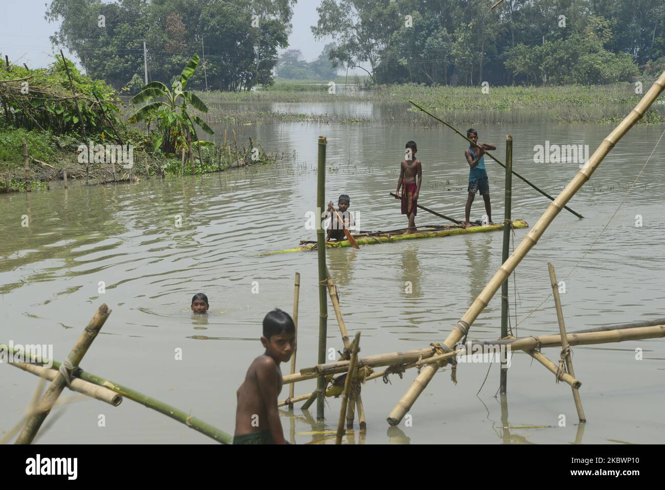 Villagers ride on makeshift raft made of banana trees in the flood ...