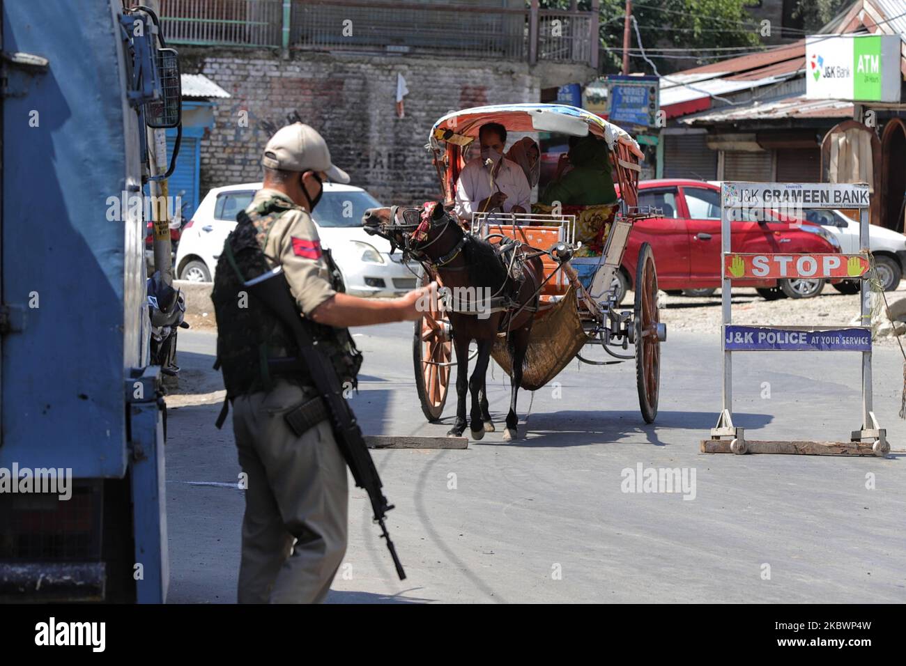 A police Cop stops a Horse-driven carriage in Sopore Town of District ...