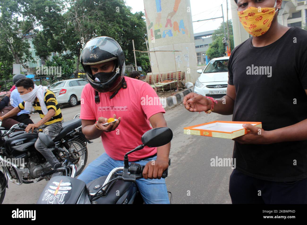 People distribute Laddoo's (sphere-shaped sweet) in New Delhi as Prime ...