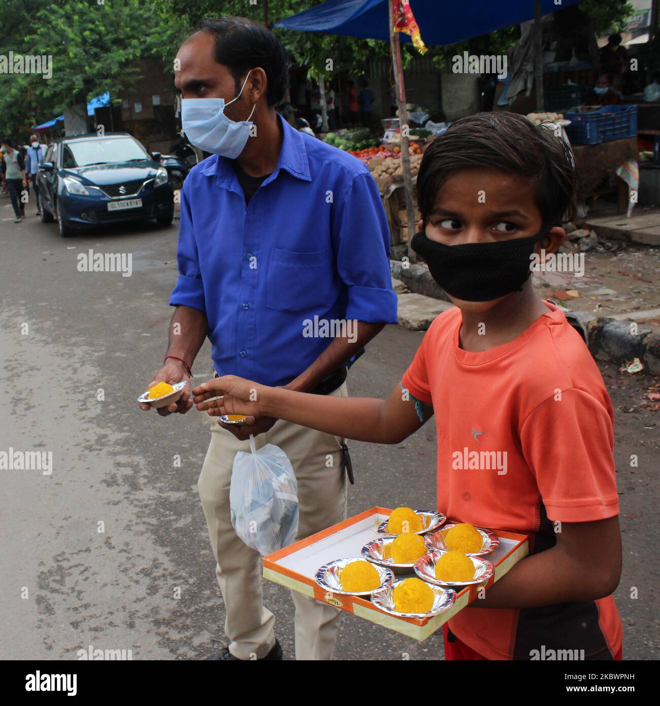 People distribute Laddoo's (sphere-shaped sweet) in New Delhi as Prime ...