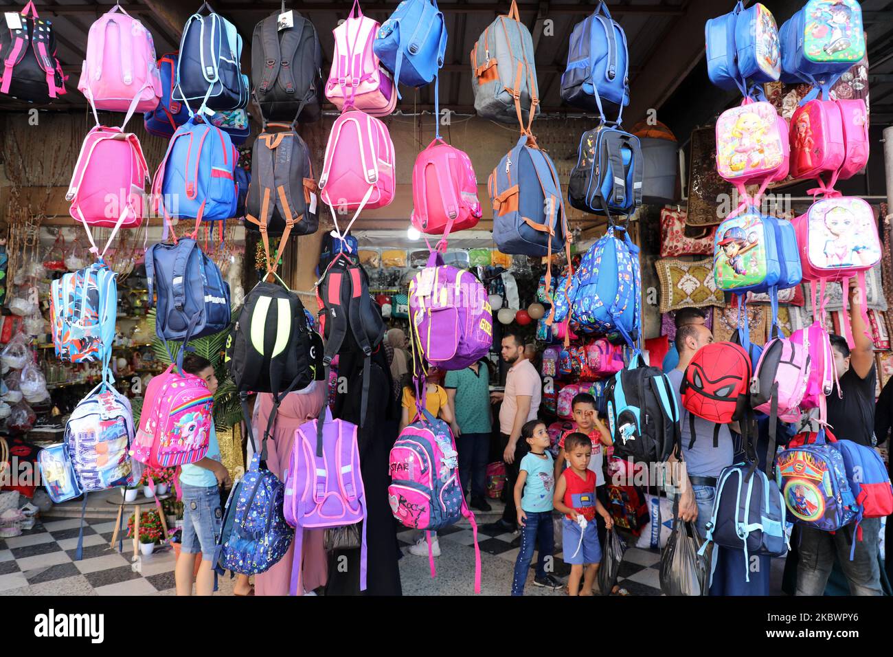 Palestinians shop during preparation for the new school year at a ...