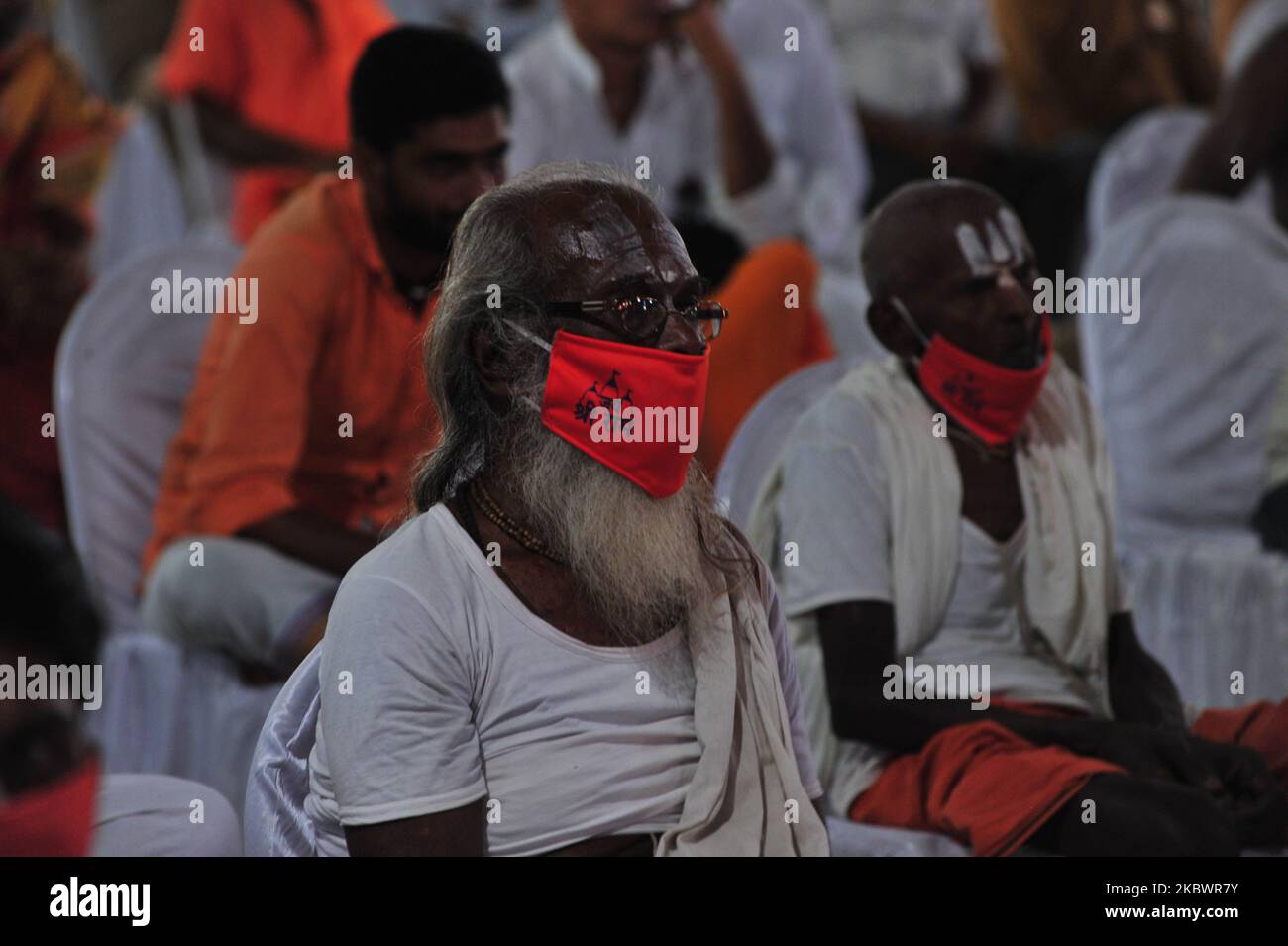 A saint wearing protective mask as others watches Ground breaking ...