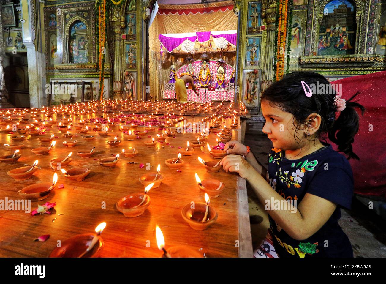 Hindu devotees light earthen lamps at Ramchandra Ji Temple to celebrate ...