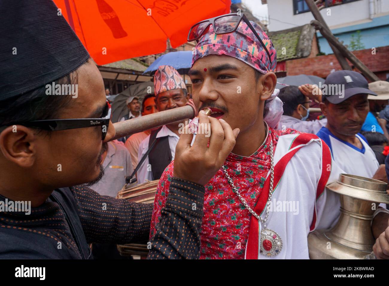 Nepalese man dress in traditional festival attire does final make-up as ...