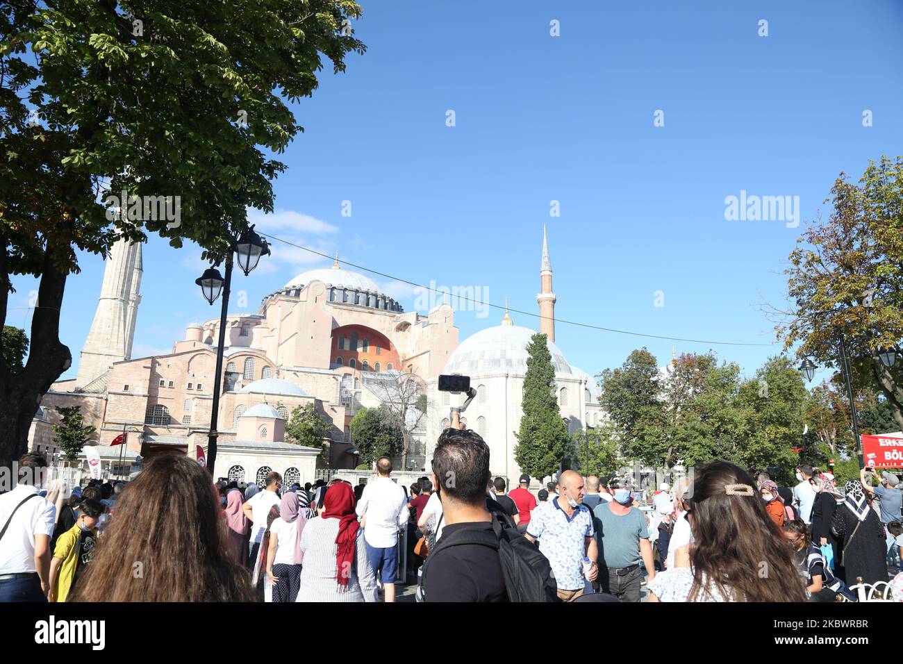 People wait for noon prayer in front of the Hagia Sophia Mosque in ...