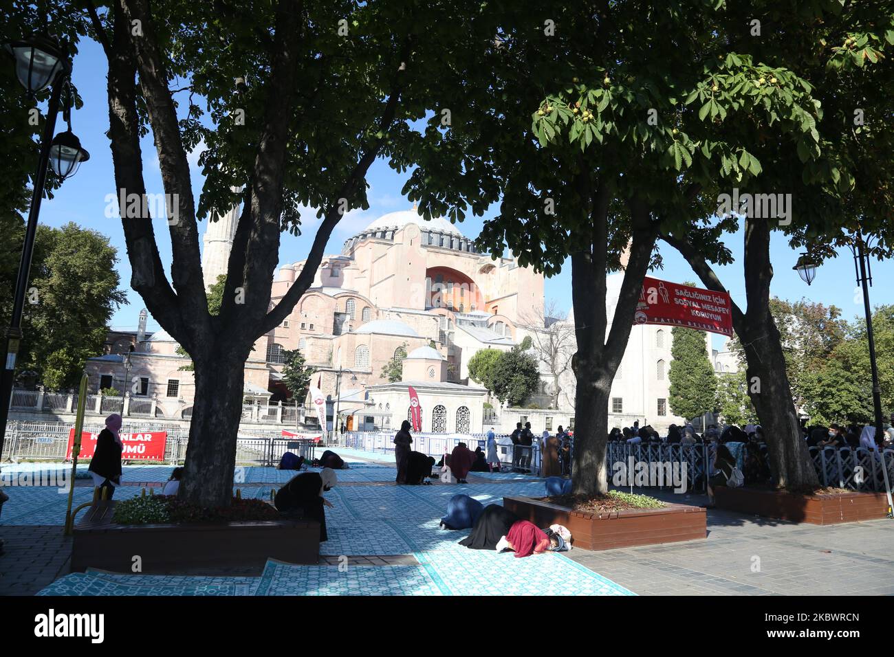 People wait for noon prayer in front of the Hagia Sophia Mosque in ...