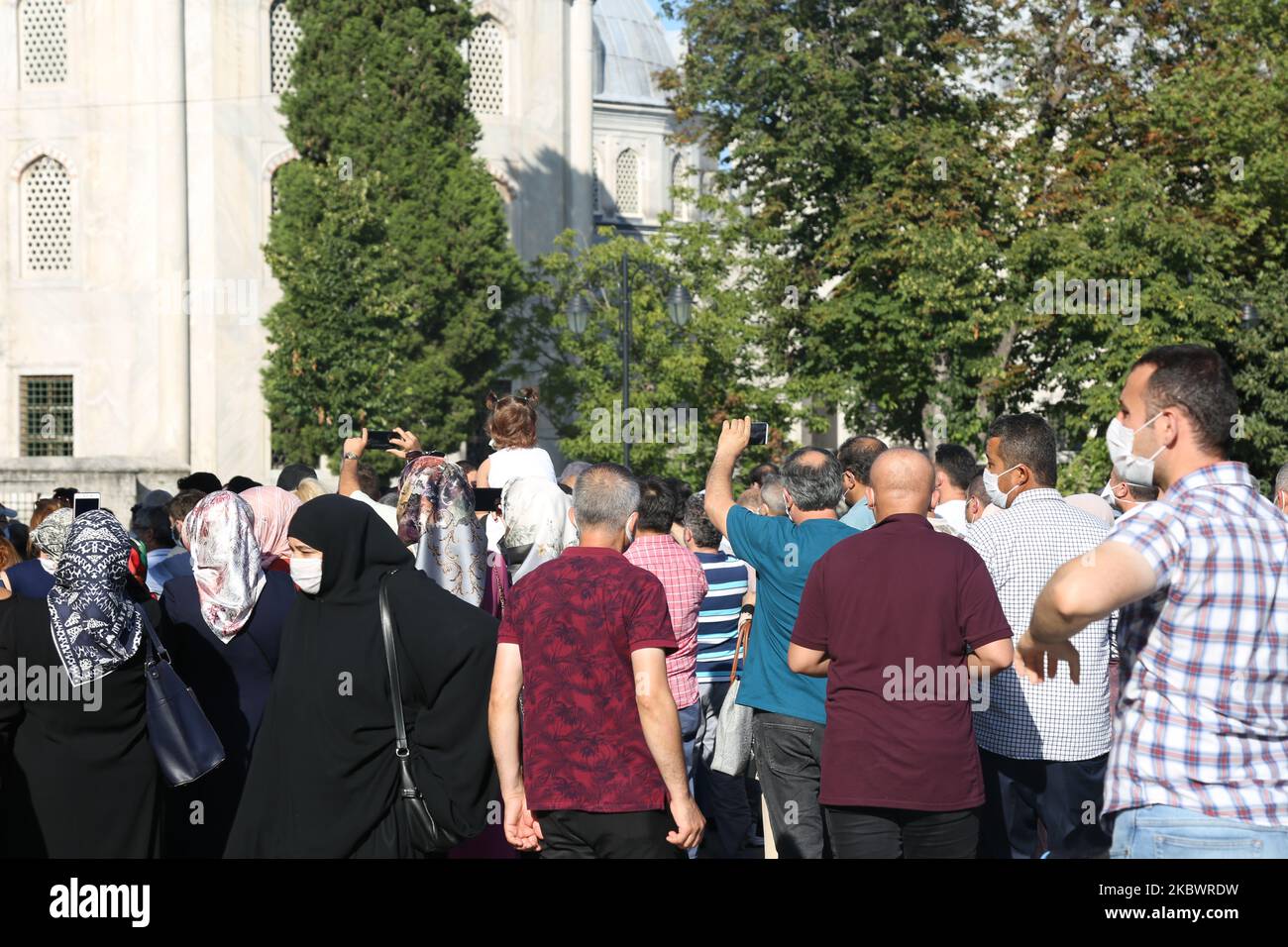 People wait for noon prayer in front of the Hagia Sophia Mosque in ...