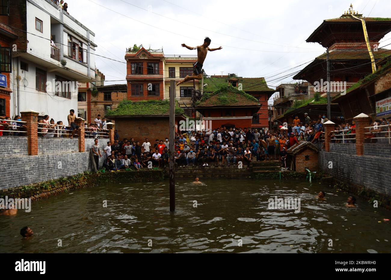 Nepalese devotees jump into a pond during deopokhari Jatra also know as ...