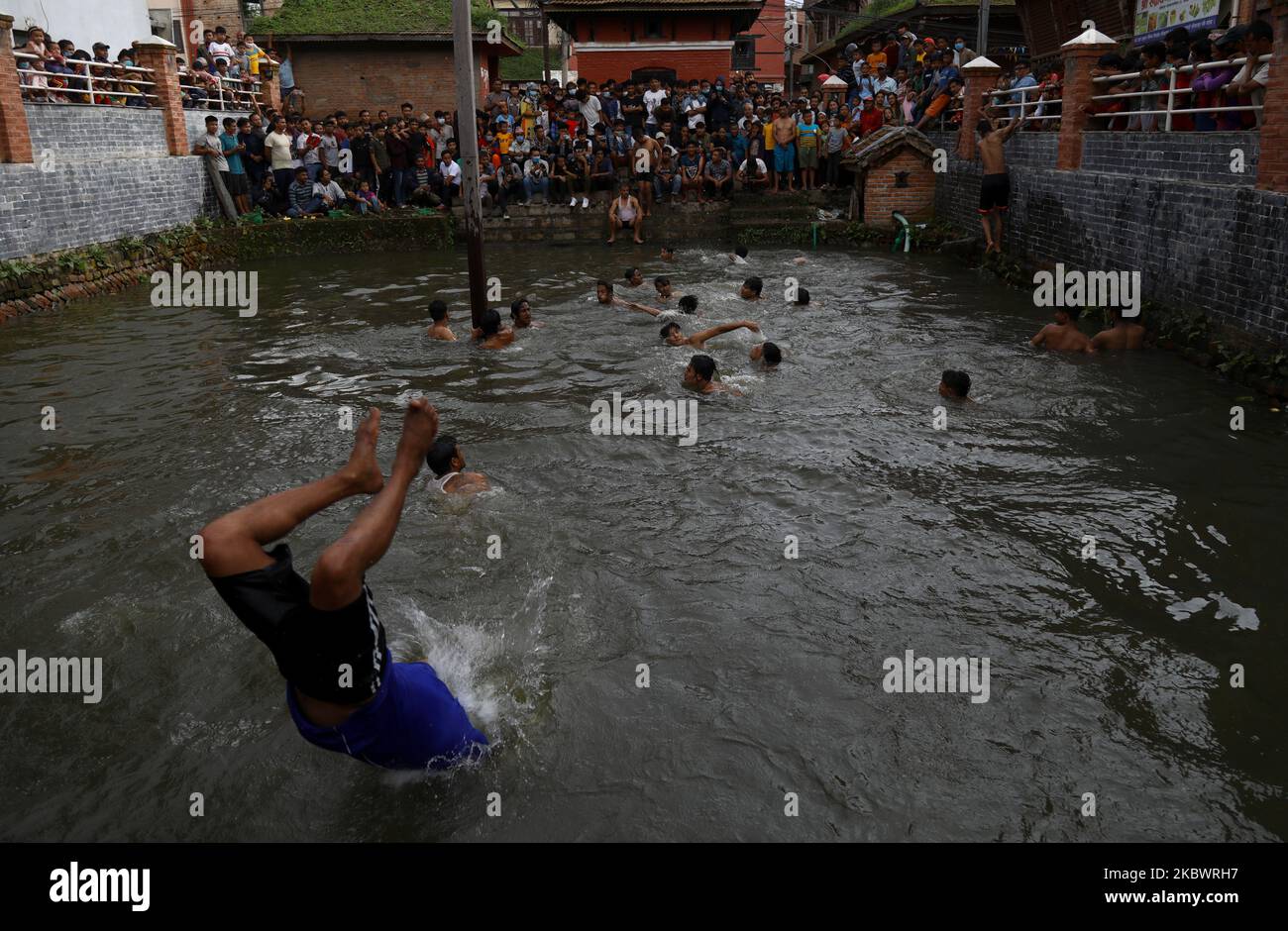 Nepalese devotees jump into a pond during deopokhari Jatra also know as ...