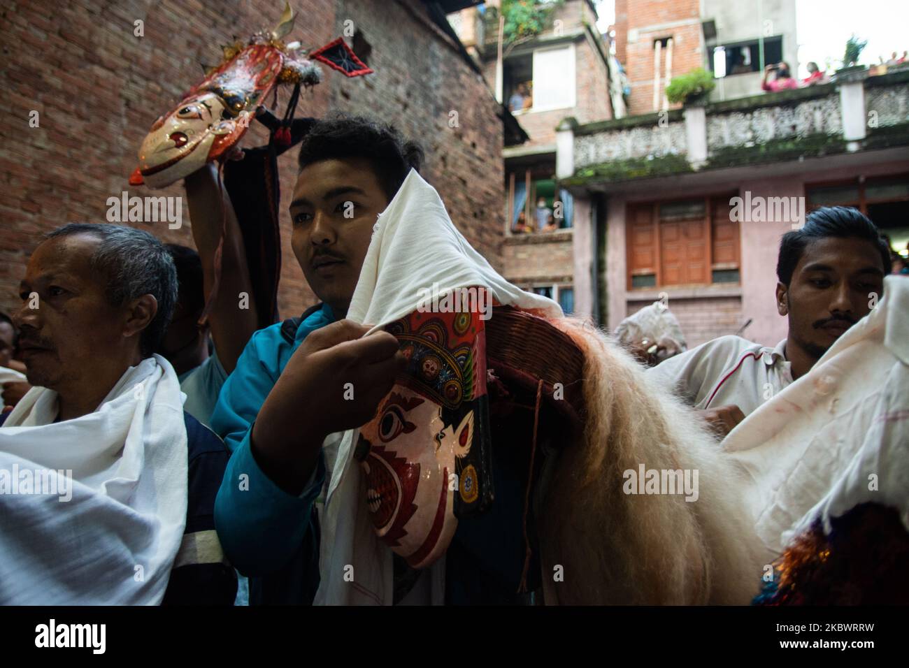 Devotee covers traditional mask after the procession during Nil Barahi ...