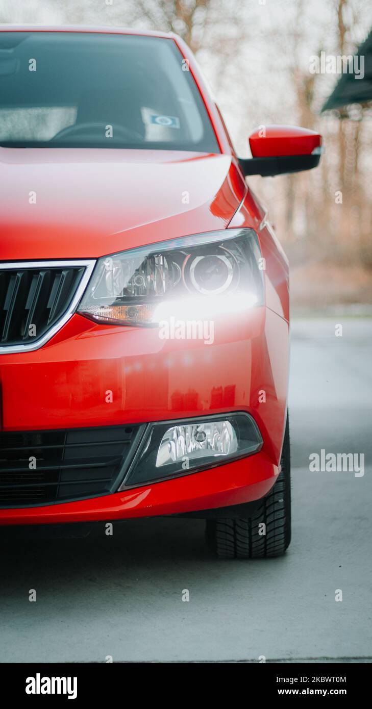 A vertical front view of a red car headlight Stock Photo - Alamy