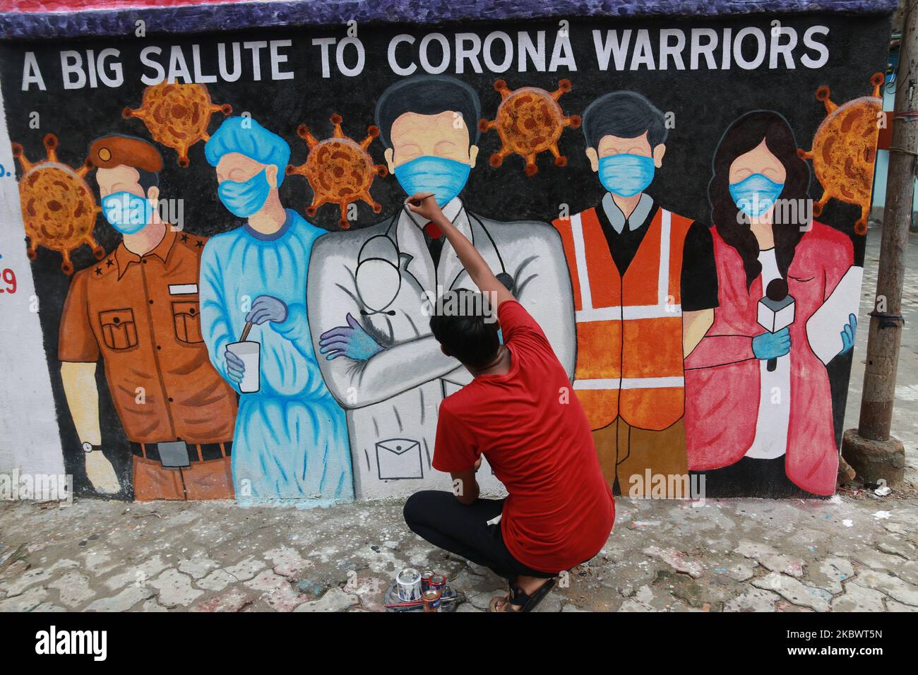 Indian artist gives finishing touches to a mural depicting frontline ...