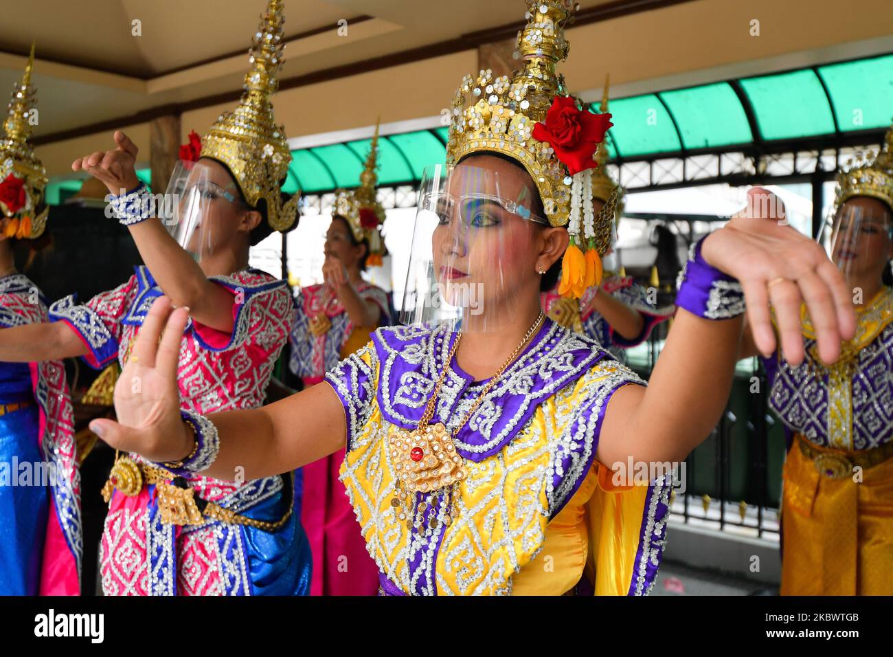 Traditional Thai dancers wearing face shields perform at the Erawan ...
