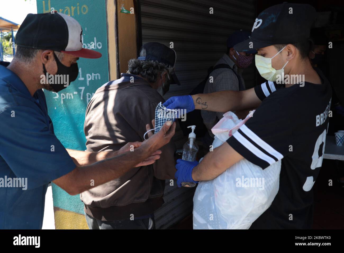 Honduran migrants eat at a religious association dining room in Mexico ...