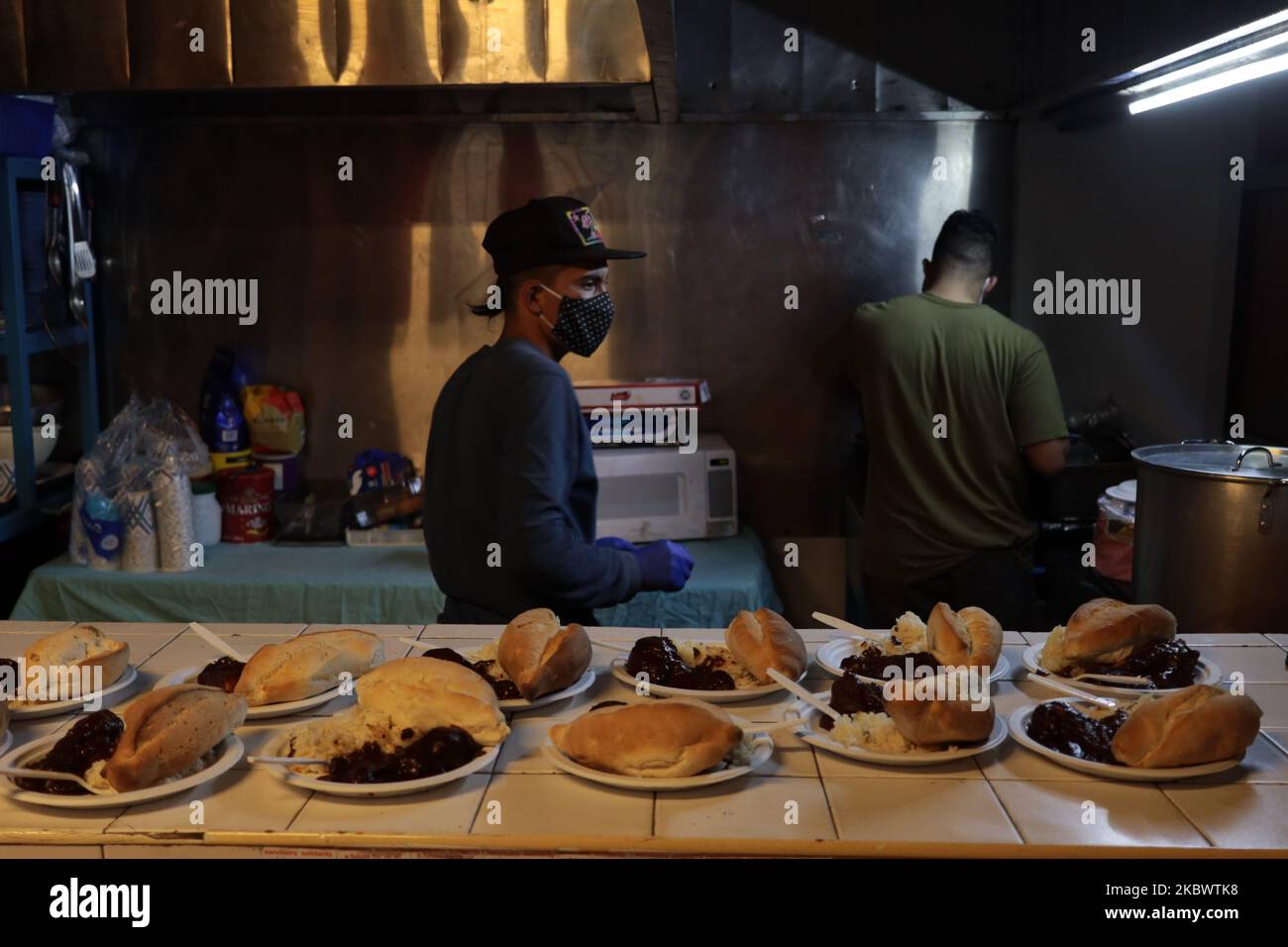 Honduran migrants eat at a religious association dining room in Mexico ...