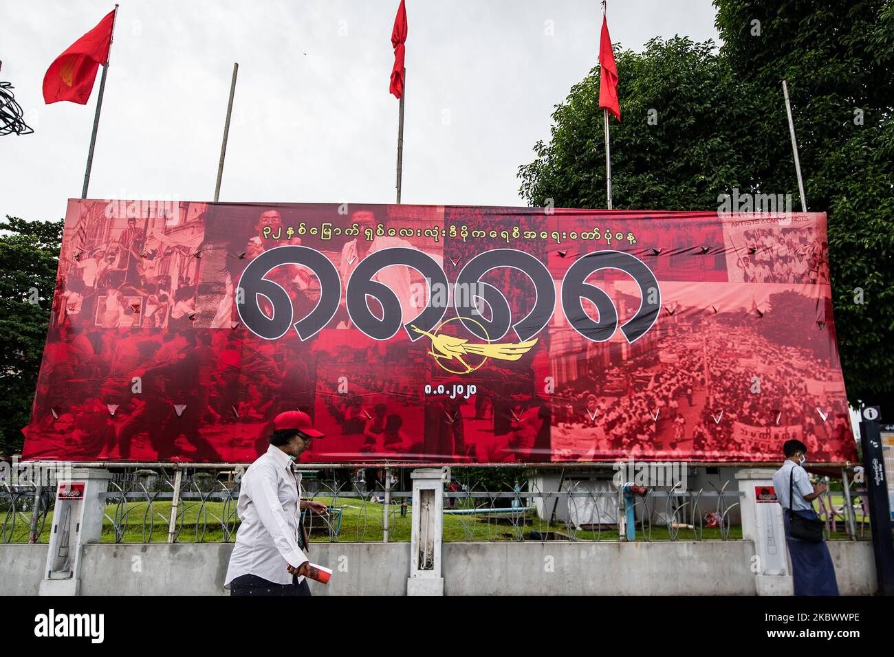 A woman walks near a poster during a ceremony to mark the 32nd ...