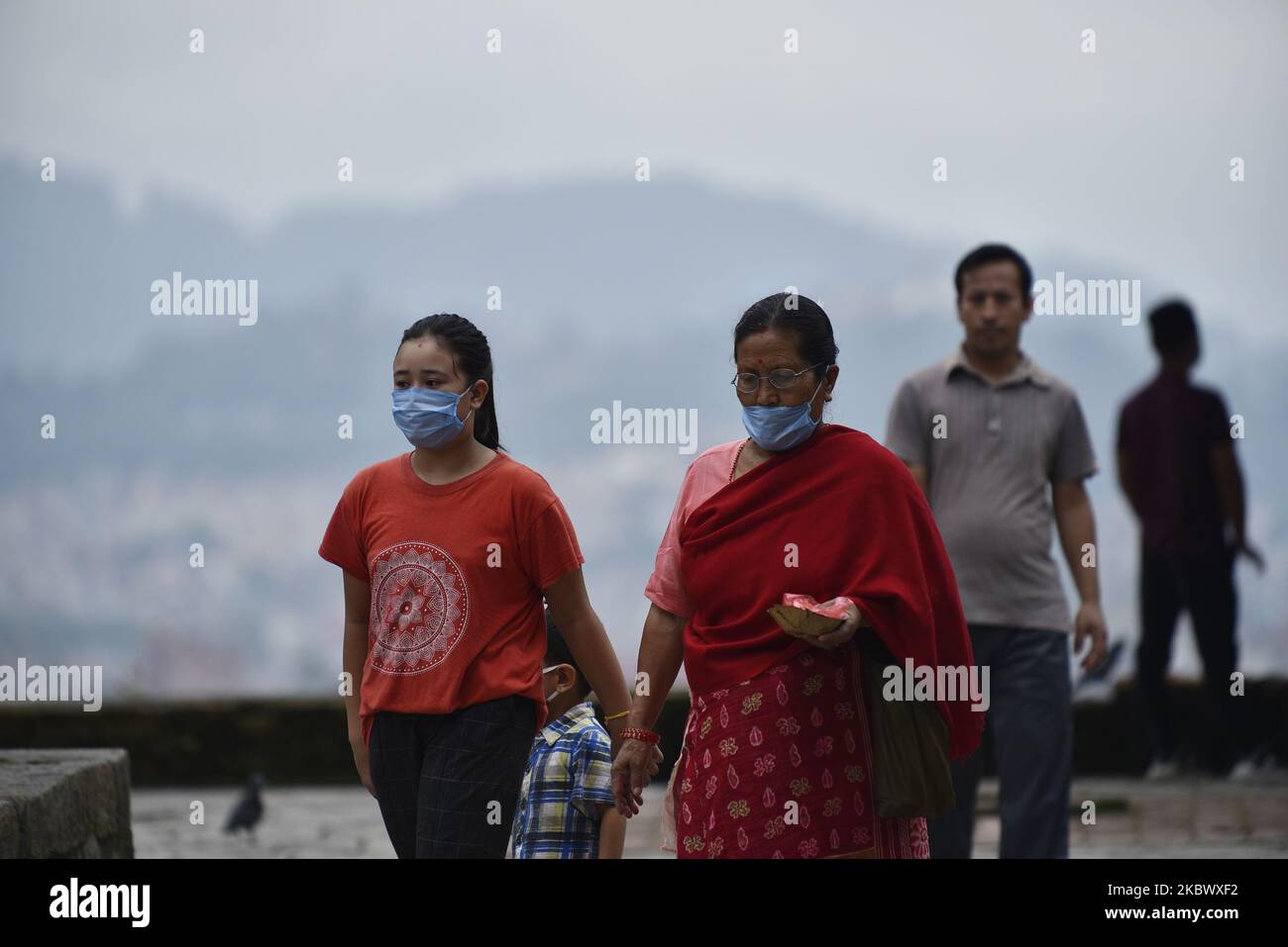 Nepalese devotee along with the face mask arrive to offer ritual prayer ...
